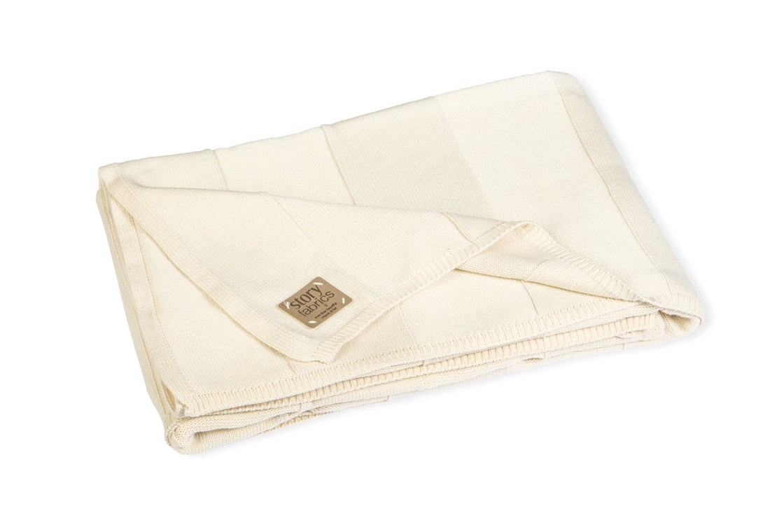 Throw with elephant print in blue, lilac, beige.